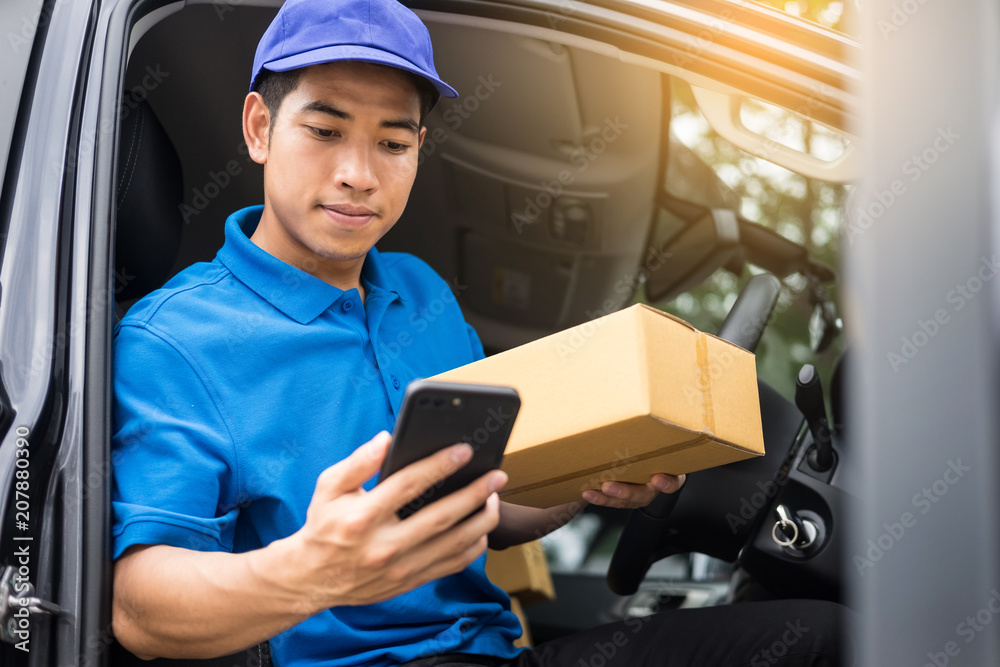 messenger man hold box and talk on smart phone and payment terminal in ...