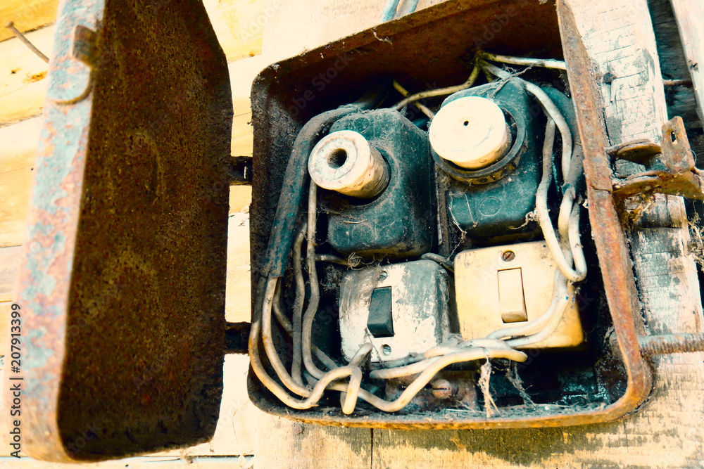 Old electric power supply boxes. Industrial background. Overloaded ...