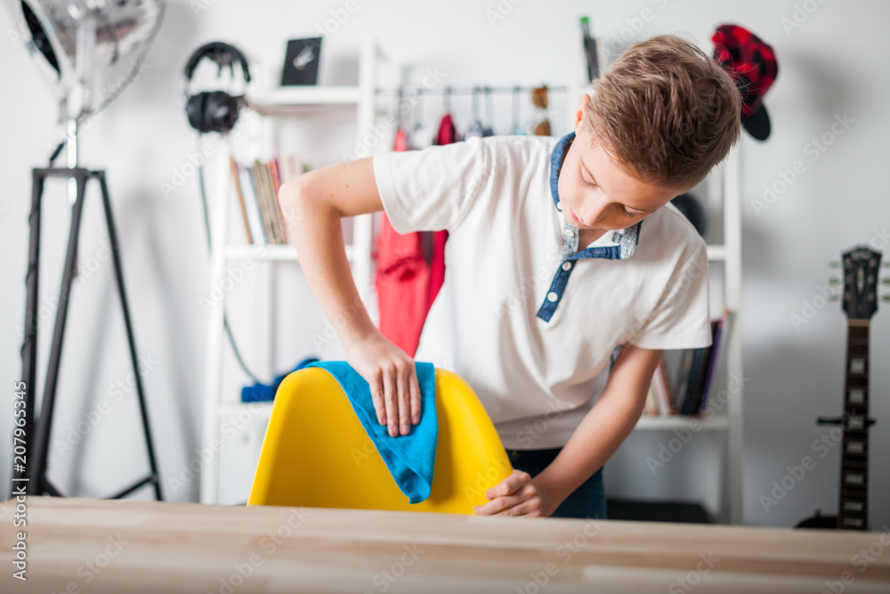 Preteen boy doing housework and cleaning his room Stock Photo | Adobe Stock