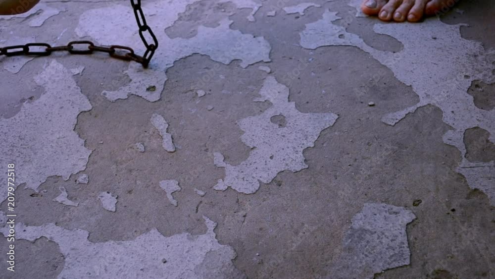 Girl, woman chained to her leg Stock Video | Adobe Stock