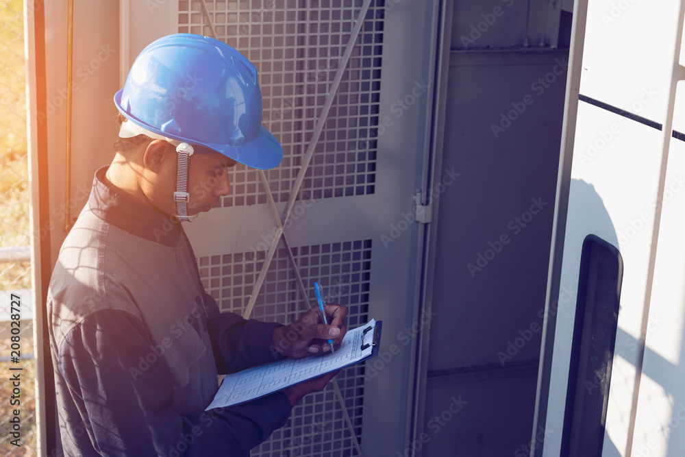 engineer or electrician working on checking and maintenance equipment ...
