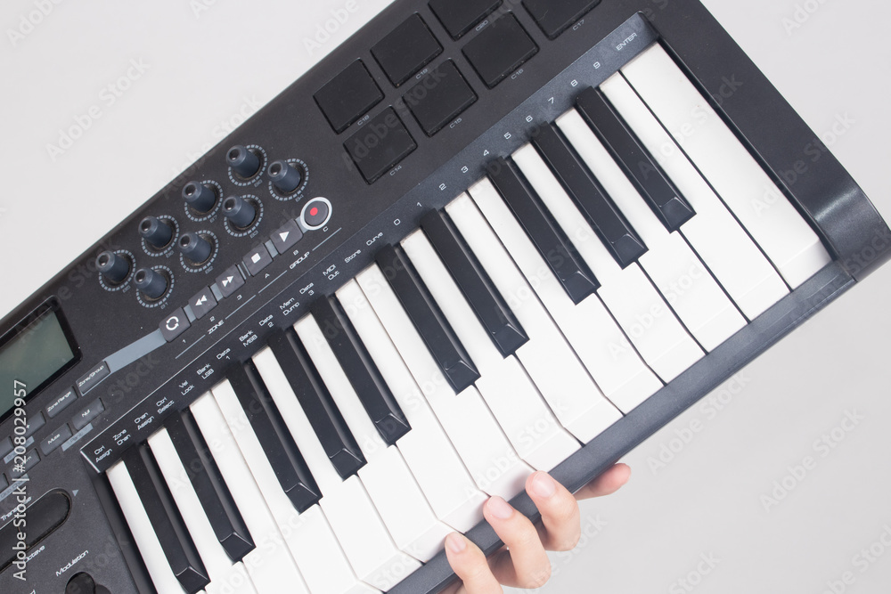 midi controller keyboard holding on hand. black and white color. Stock ...