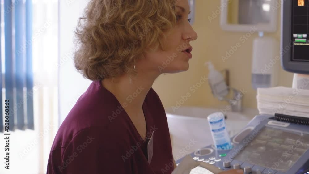 attractive woman obstetrician gynecologist, makes an examination ...