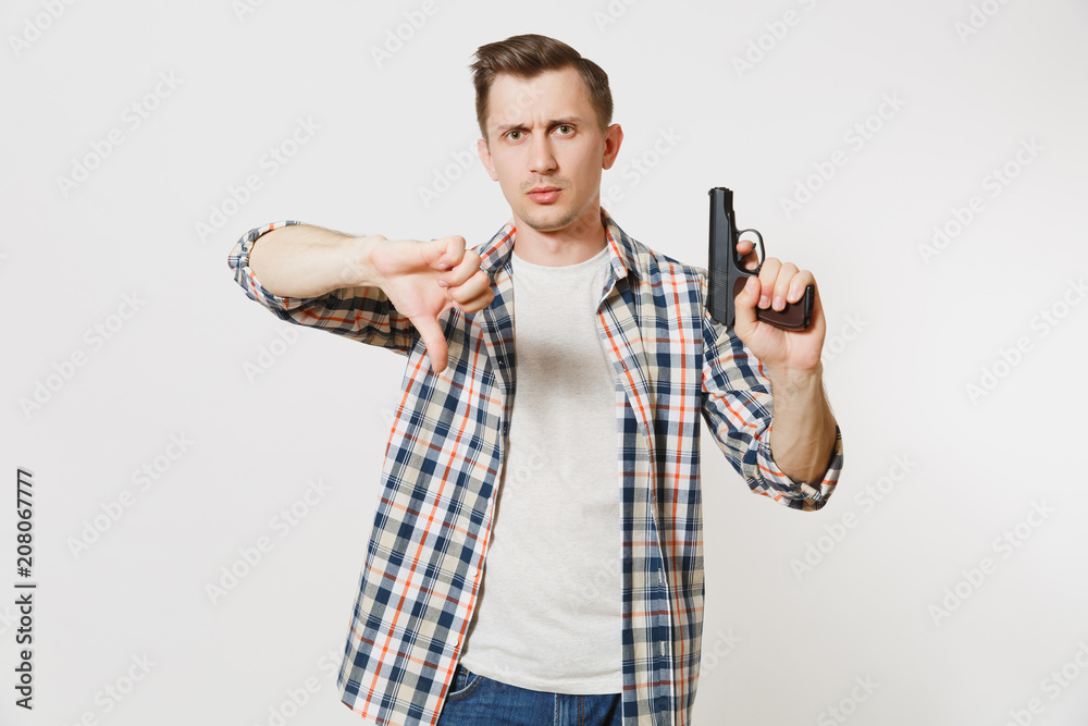 Upset man with gun in hand showing thumbs down gesture isolated on ...