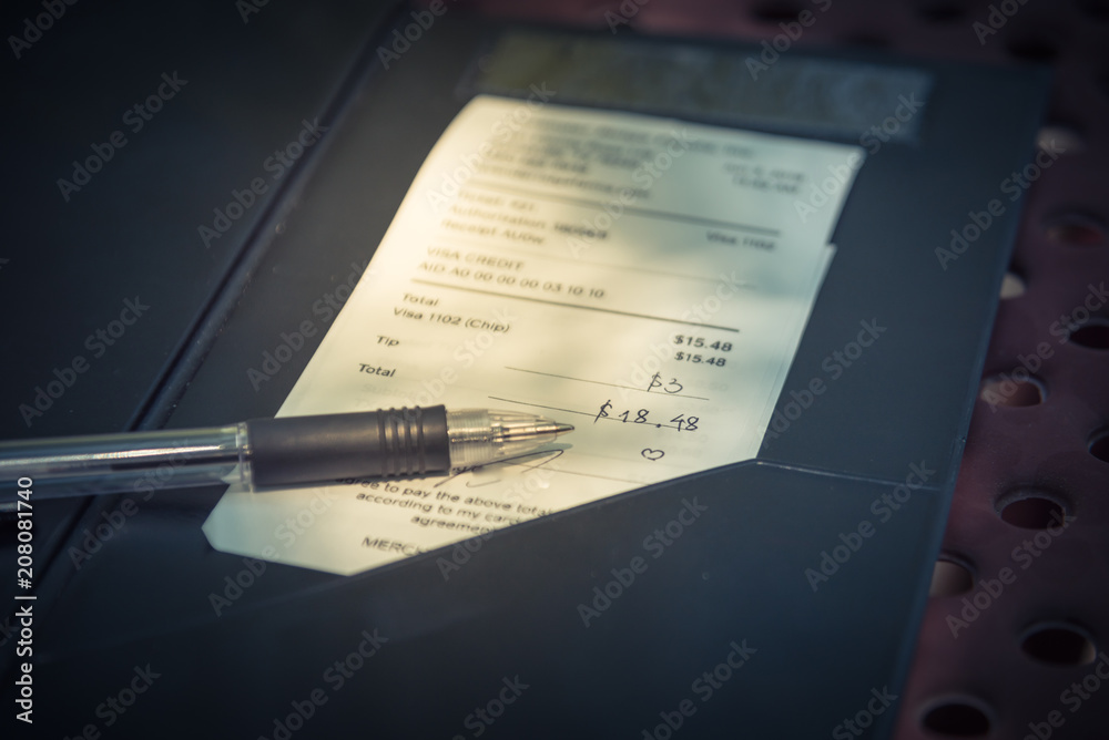 Vintage tone open leather bill holder restaurant check, pen. Soft focus ...