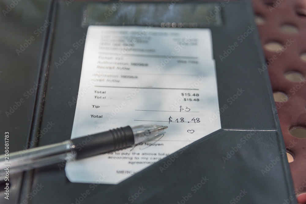 Open leather bill holder with restaurant check and pen. Soft focus ...