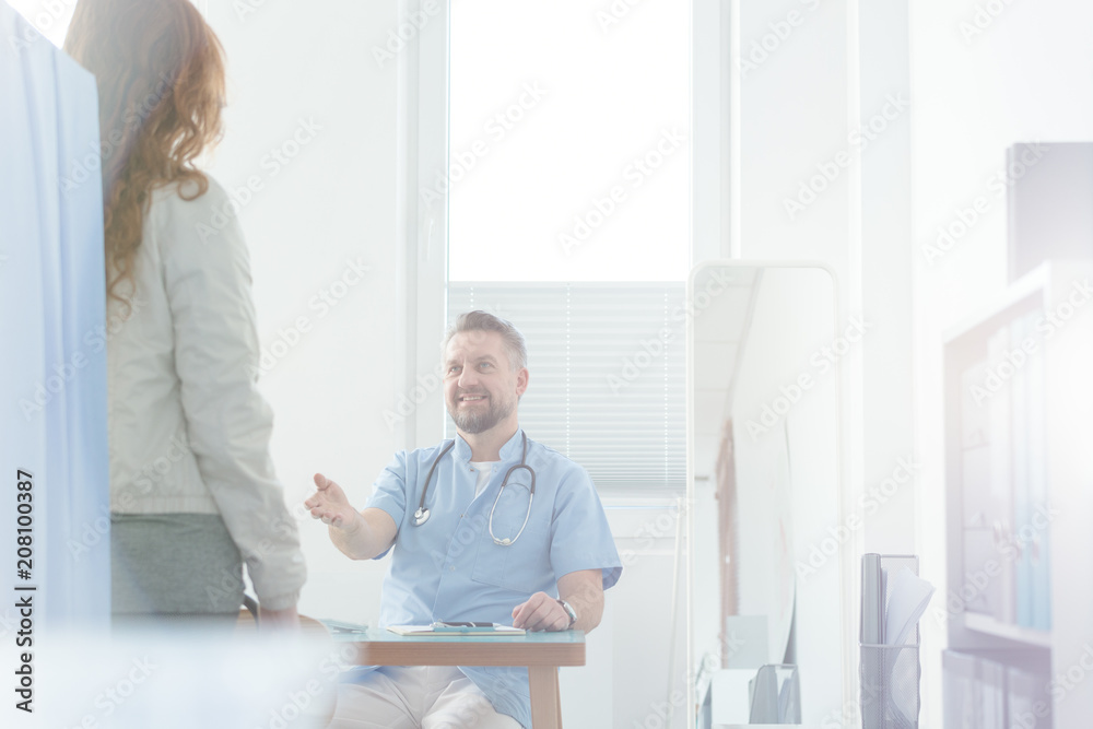 Smiling general practitioner welcoming patient Stock Photo | Adobe Stock