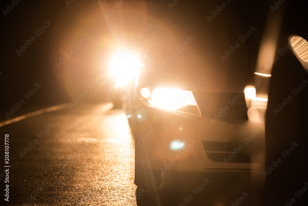 Halogen headlight lamps of cars in the night. Stock Photo | Adobe Stock