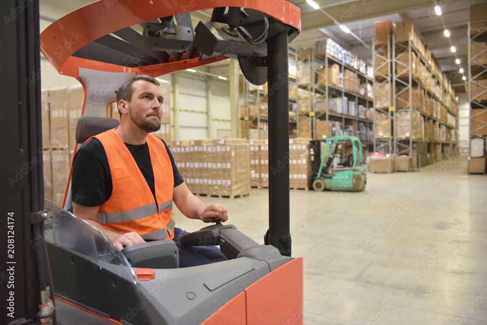 Workers in the warehouse of a forwarding company using forklifts for ...