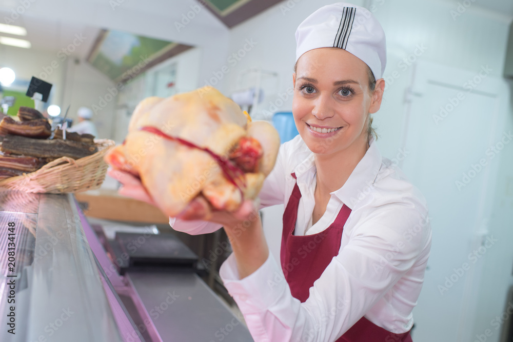happy female butcher showing meat Stock-Foto | Adobe Stock