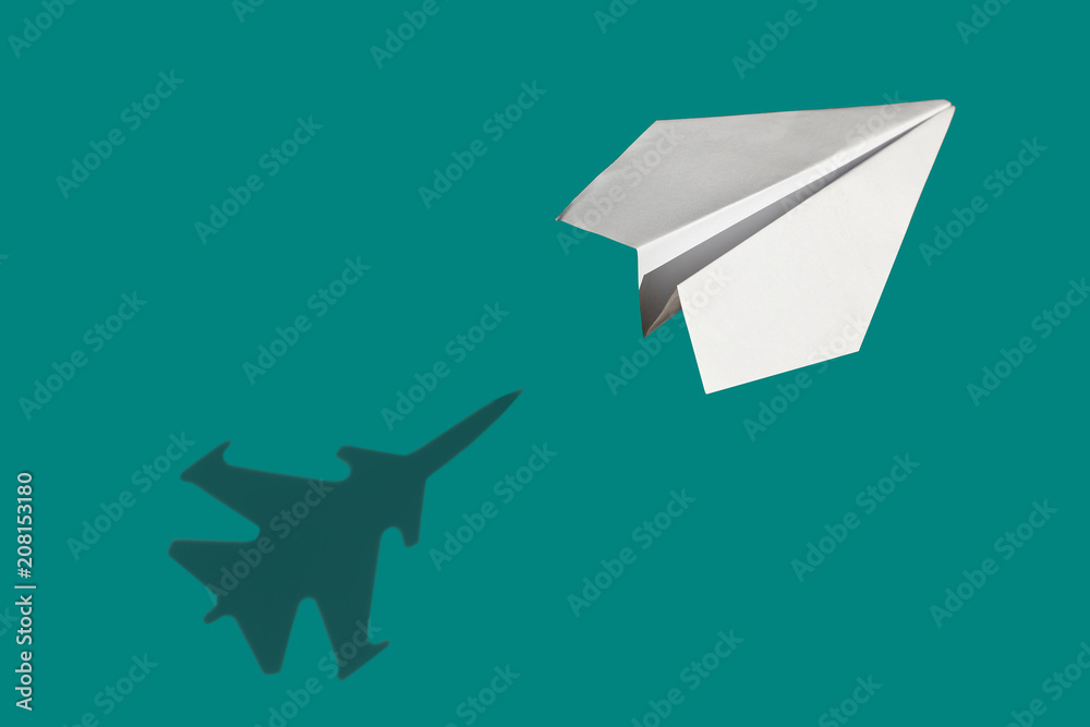 Flying a paper airplane with aggressive shadow combat aircraft-fighter ...