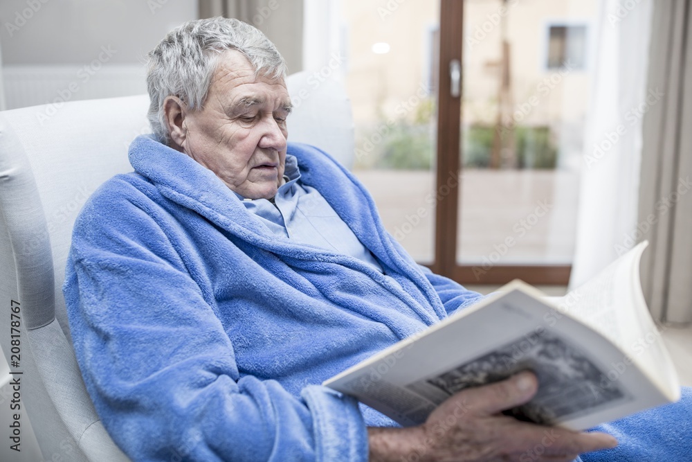 Senior man reading magazine Stock Photo | Adobe Stock