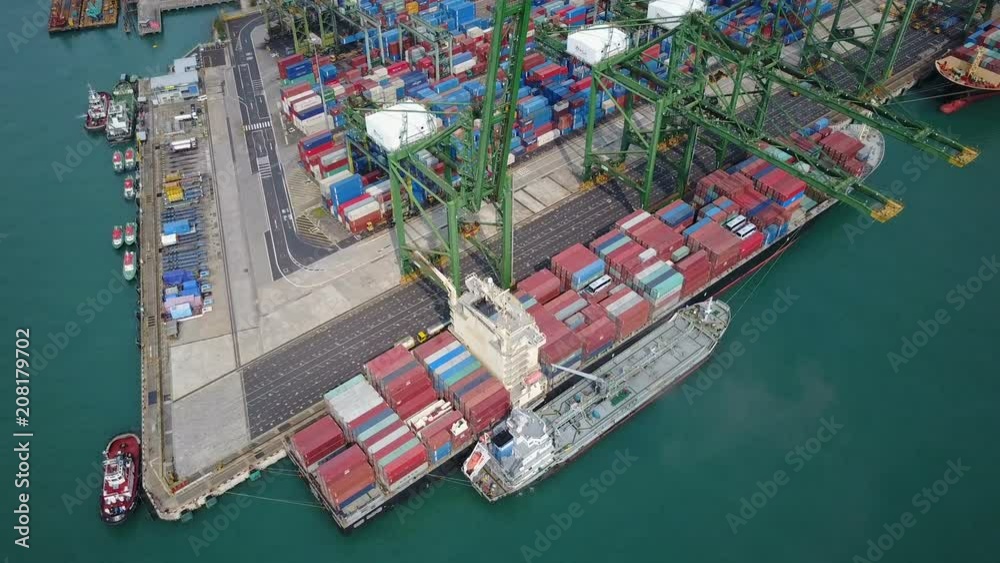 Aerial view of an international cargo ship being loaded and refueled in ...