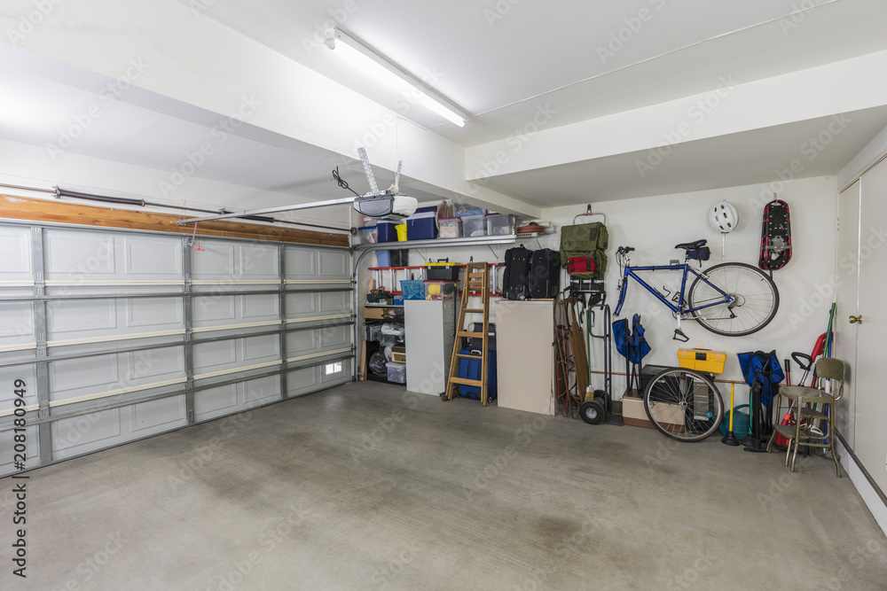 Clean suburban two car garage interior with tools, file cabinets and ...