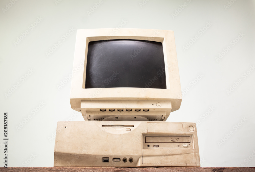 Front side of old and obsolete computer on old wood table with coloured ...