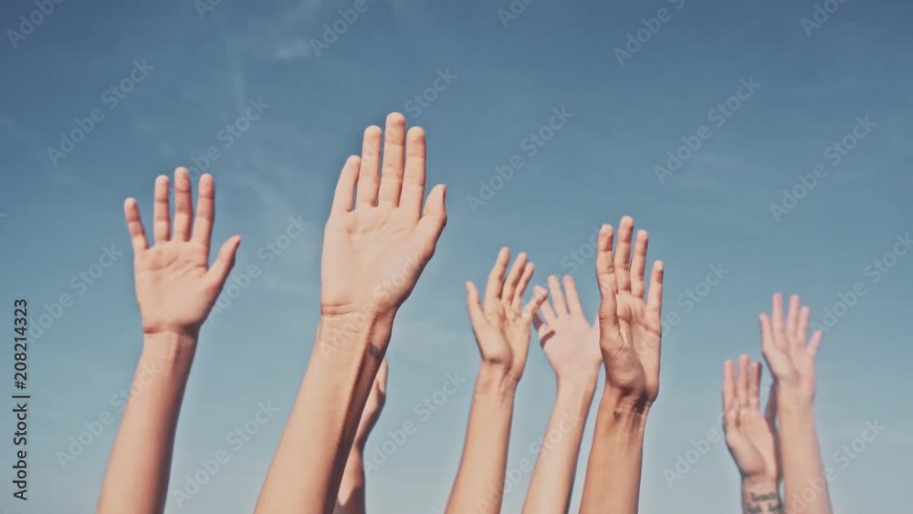 People rasing hands on blue sky background. Voting, democracy or ...