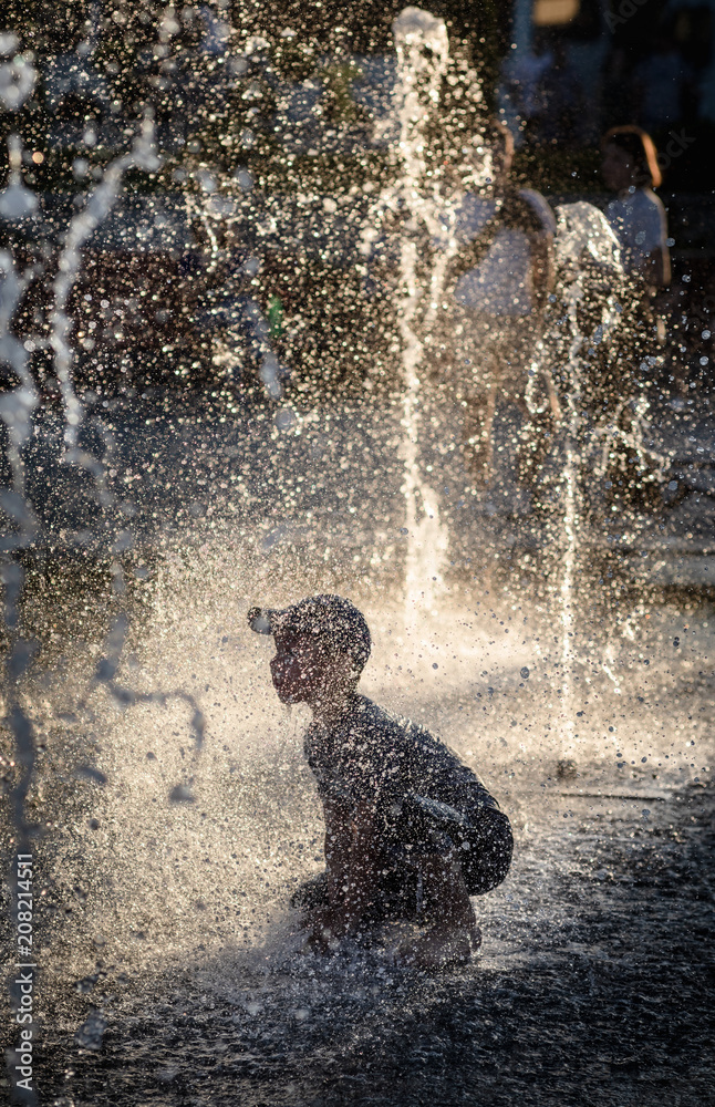 Children playing in a water fountain Stock Photo | Adobe Stock
