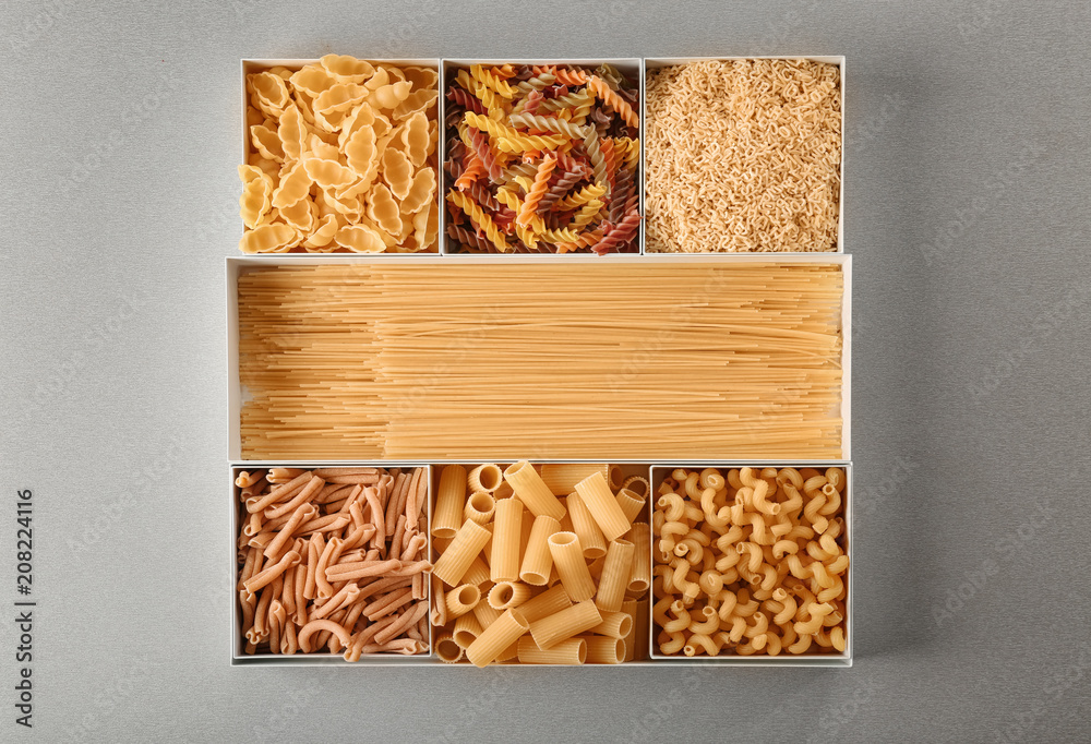 Boxes with different uncooked pasta on light background Stock Photo ...