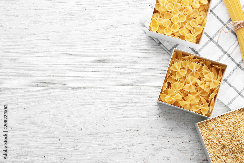 Boxes with different uncooked pasta on light background Stock Photo ...