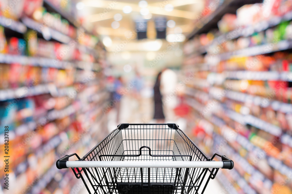 Shopping trolley in department store with goods shelf background Stock ...