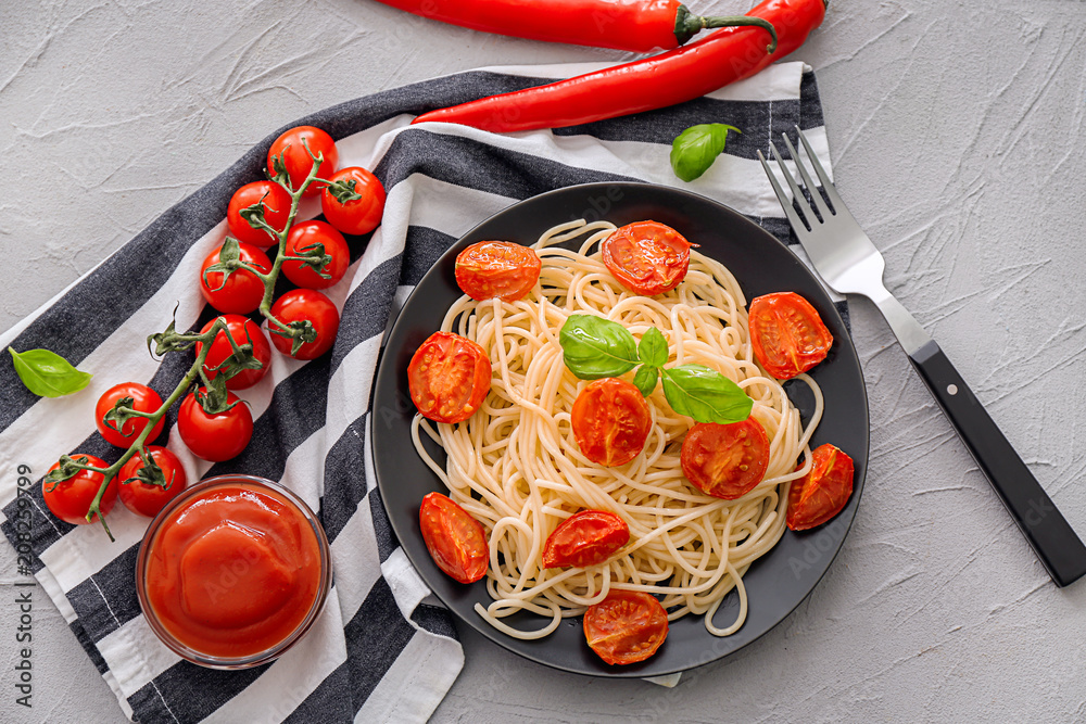 Plate of delicious pasta with tomatoes on table Stock Photo | Adobe Stock