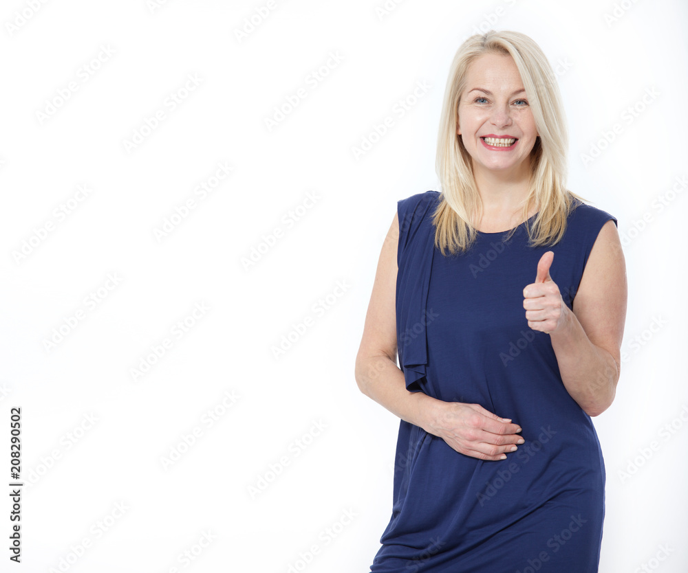 Happy caucasian female wearing blue dress making thumb up sign and ...
