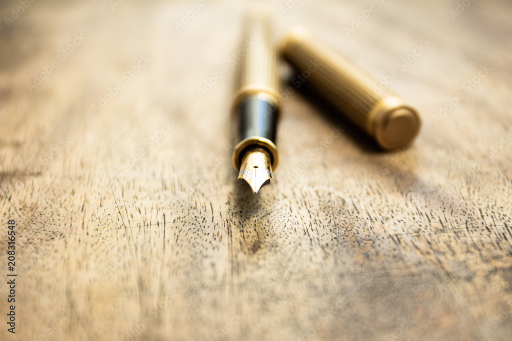 Pen. Elegant gold plated business fountain pen isolated on white with ...