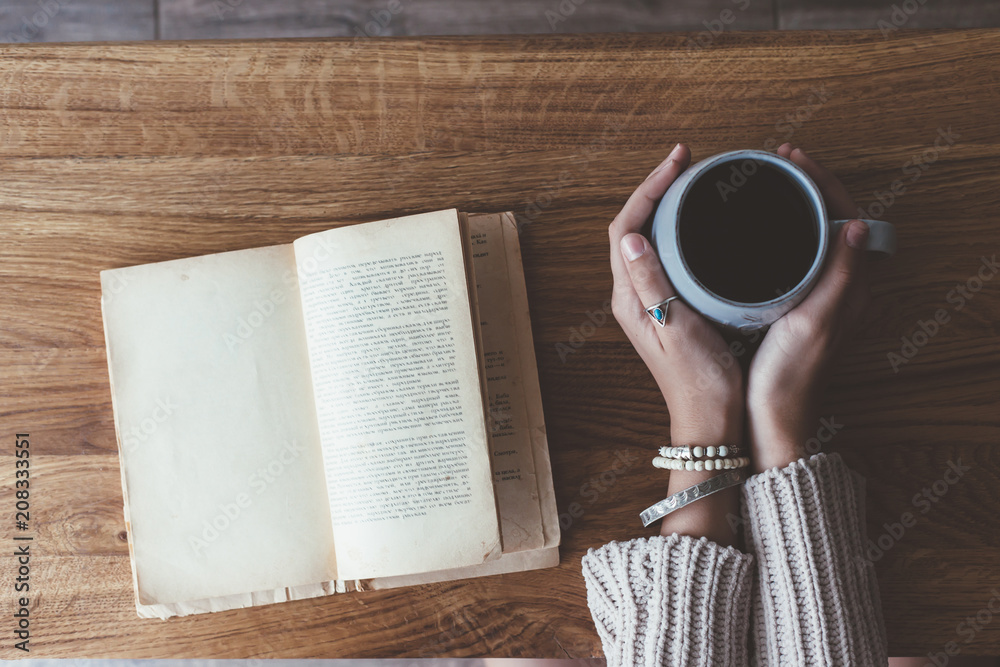Reading a book and drinking coffee in cafe Stock Photo | Adobe Stock