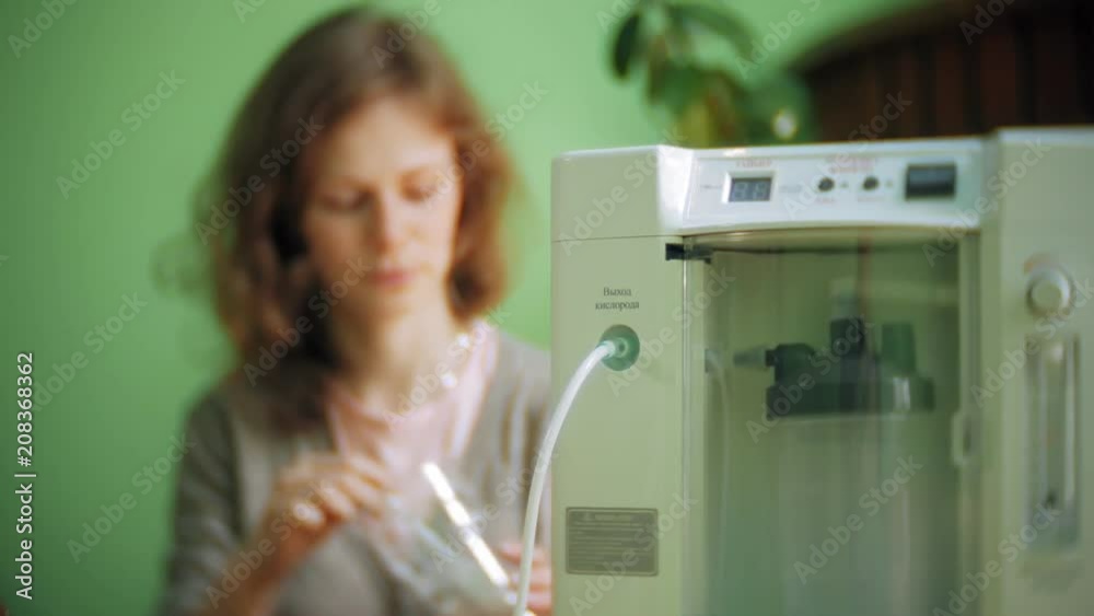A woman drinks an oxygen cocktail with a device for oxygen scum. Oxygen ...
