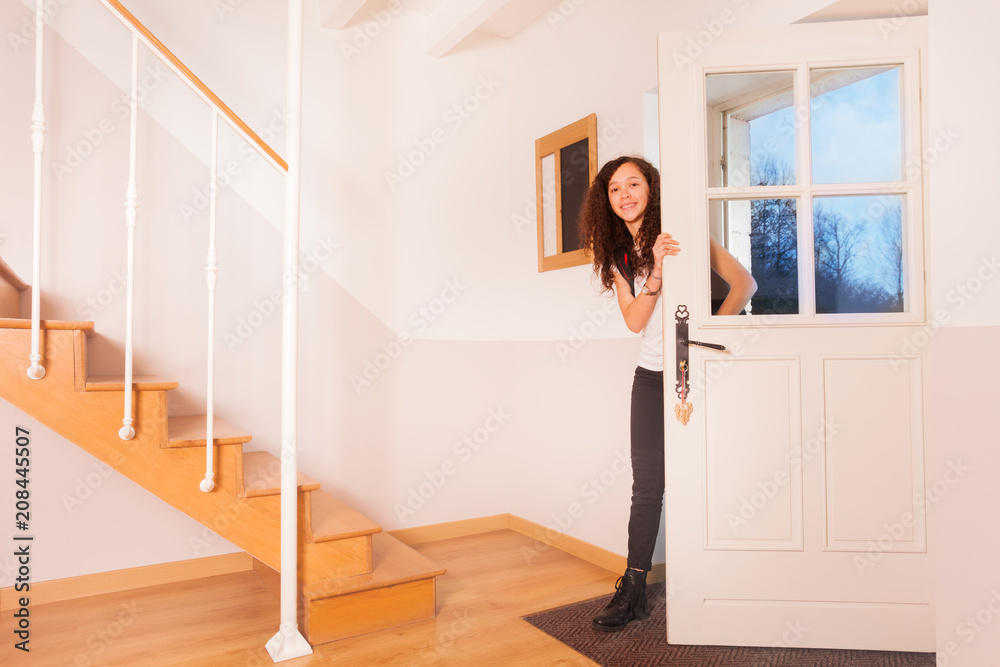 Happy teenage girl coming back home from school Stock-Foto | Adobe Stock
