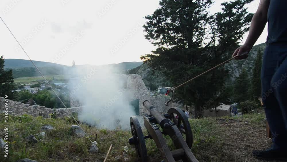 Firing a on fort. Artillery fire on a castle. Shooting from medieval ...