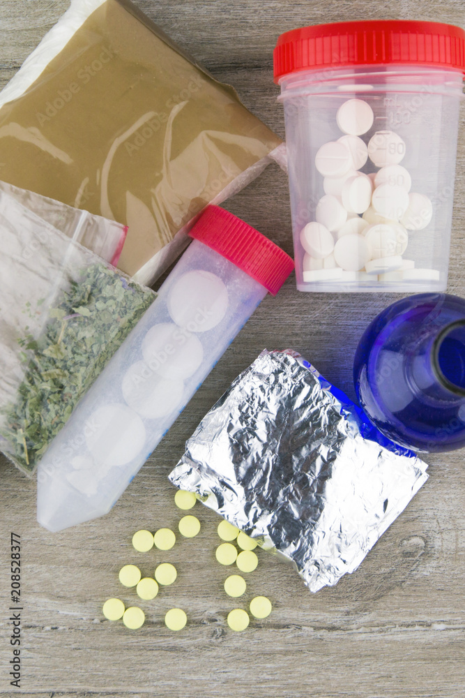 drug detection: samples of packaged drugs next to the flask of liquid ...