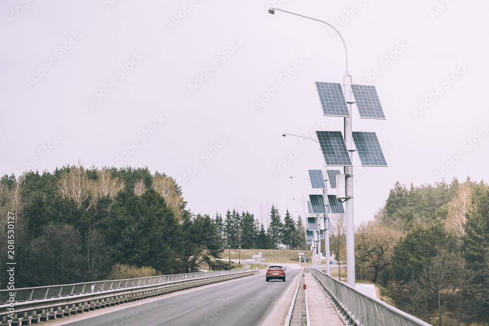 Street lamp poles powered by solar energy. Solar panels on electric ...