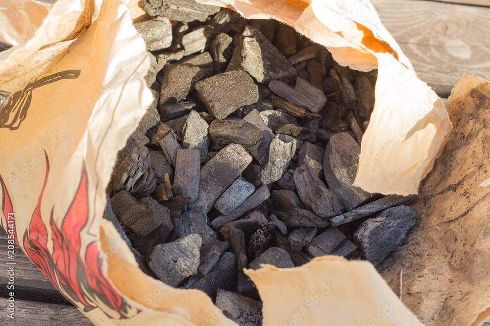 Black glossy coal for bonfire and bbq from supermarket inside a craft ...