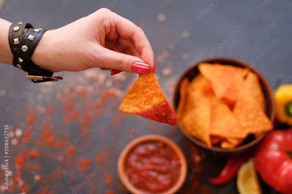 homemade fried tortilla nacho chips. delicious salty food snack. woman ...
