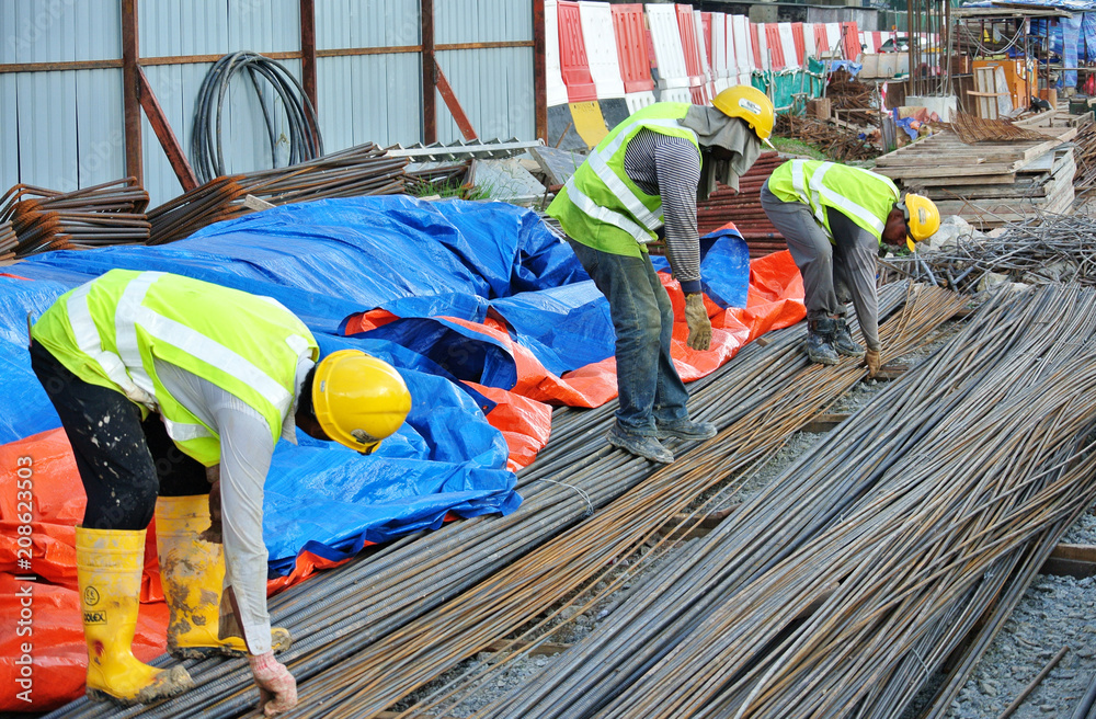 Construction workers working at the steel reinforcement bar bending ...