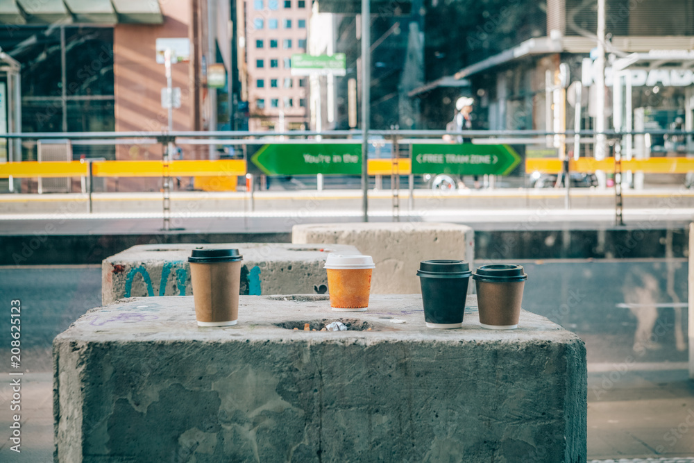 Coffee cups on concrete slab on a street in downtown Melbourne Stock ...