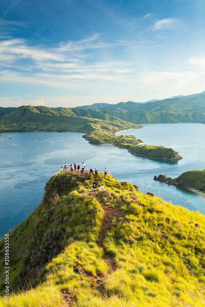 Travelers on the top view point of 'Gili Lawa' in an evening, Komodo ...
