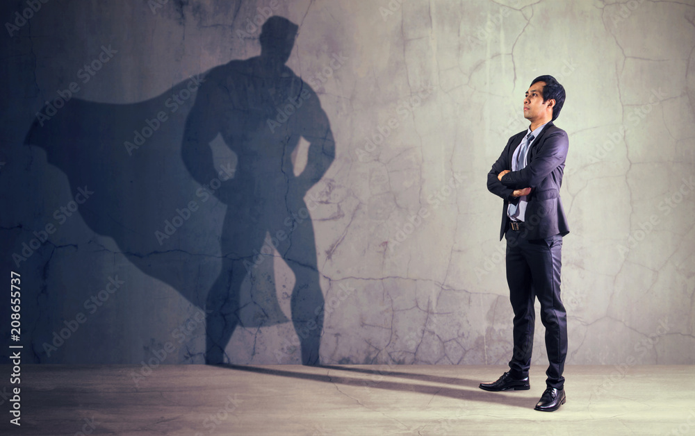 Asian businessman with his shadow of super hero on the wall. Concept of ...