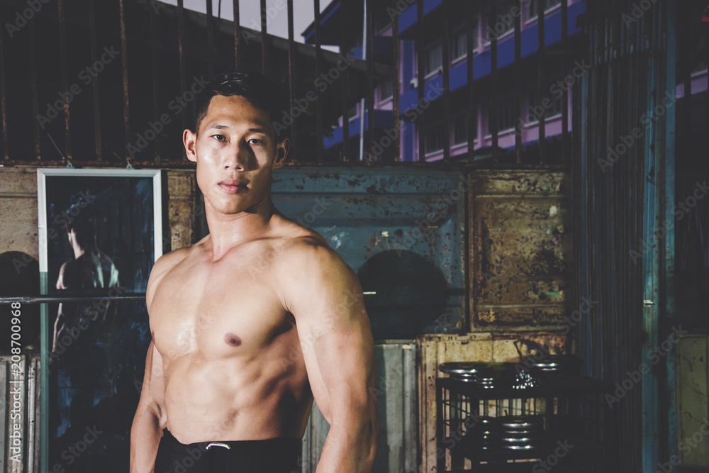 Strong Athletic Man showing muscel in local gym Stock Photo | Adobe Stock