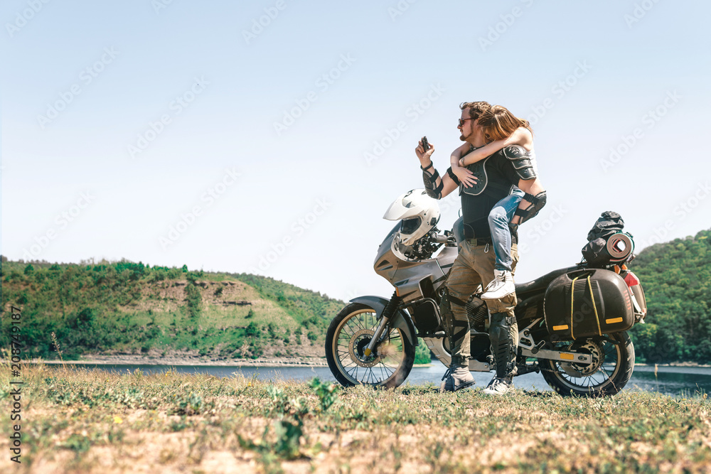 Young romantic couple having fun by the river a off road tourist ...