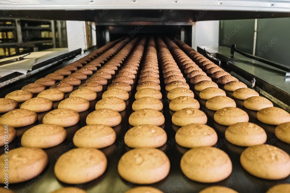 Automatic bakery production line with sweet cookies on conveyor belt ...