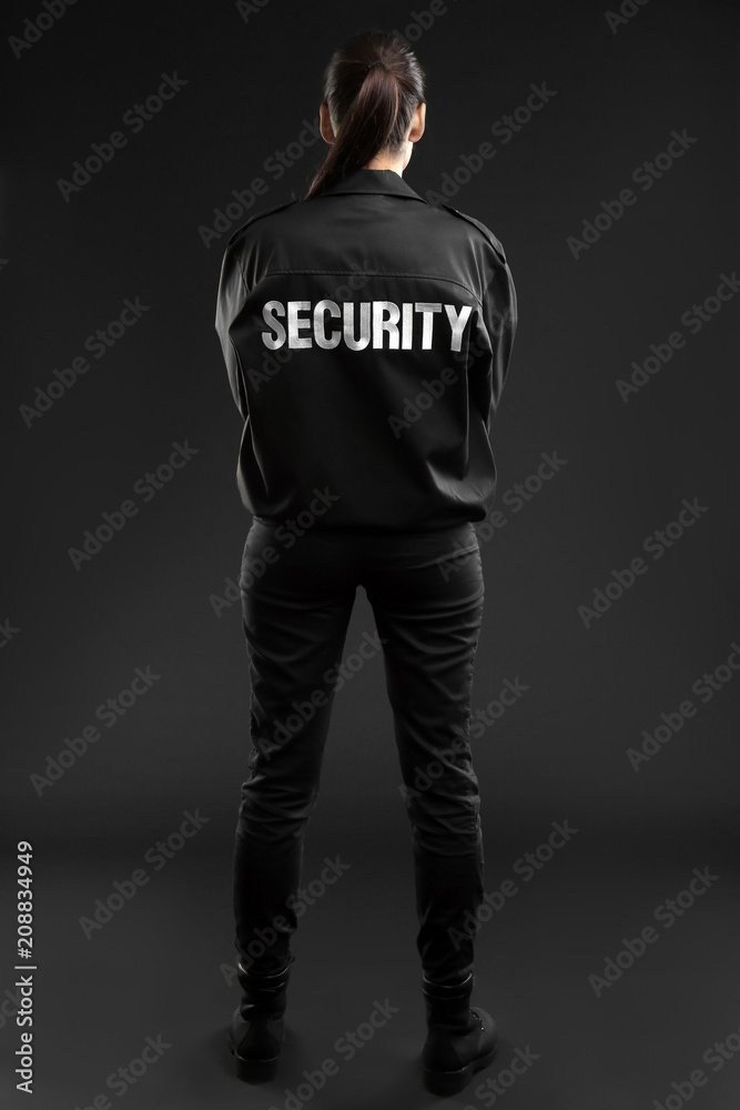 Female security guard in uniform on dark background Stock Photo | Adobe ...