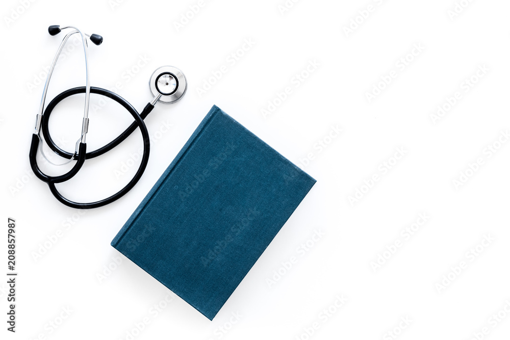 Medical education concept. Stethoscope on a textbook of medicine on ...
