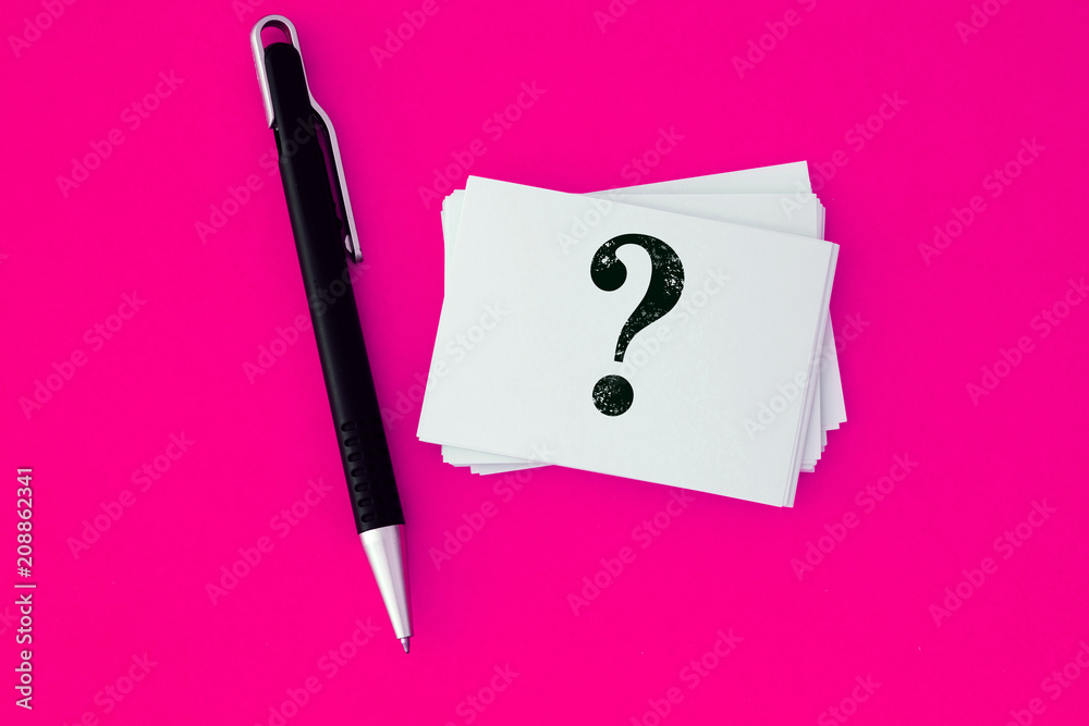 stacking of white business card with written question mark symbol on ...