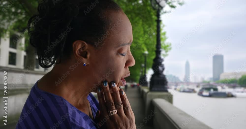 Elderly black woman looks sadly at the River Thames, Lonely African ...