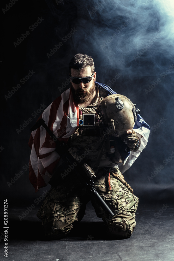 Soldier holding machine gun with national flag Stock Photo | Adobe Stock
