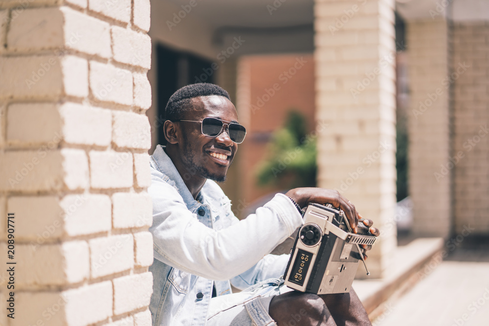 African man with vintage radio device. Stock Photo | Adobe Stock