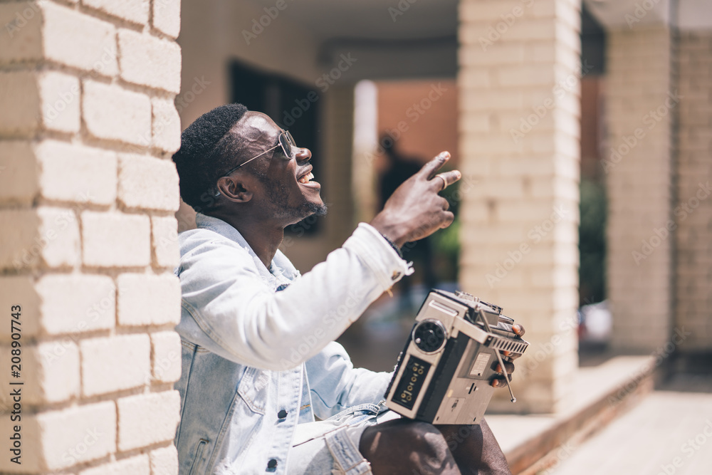 African man with vintage radio device. Stock Photo | Adobe Stock