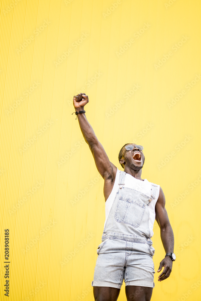 African man shouting victory clenched fist. Stock Photo | Adobe Stock
